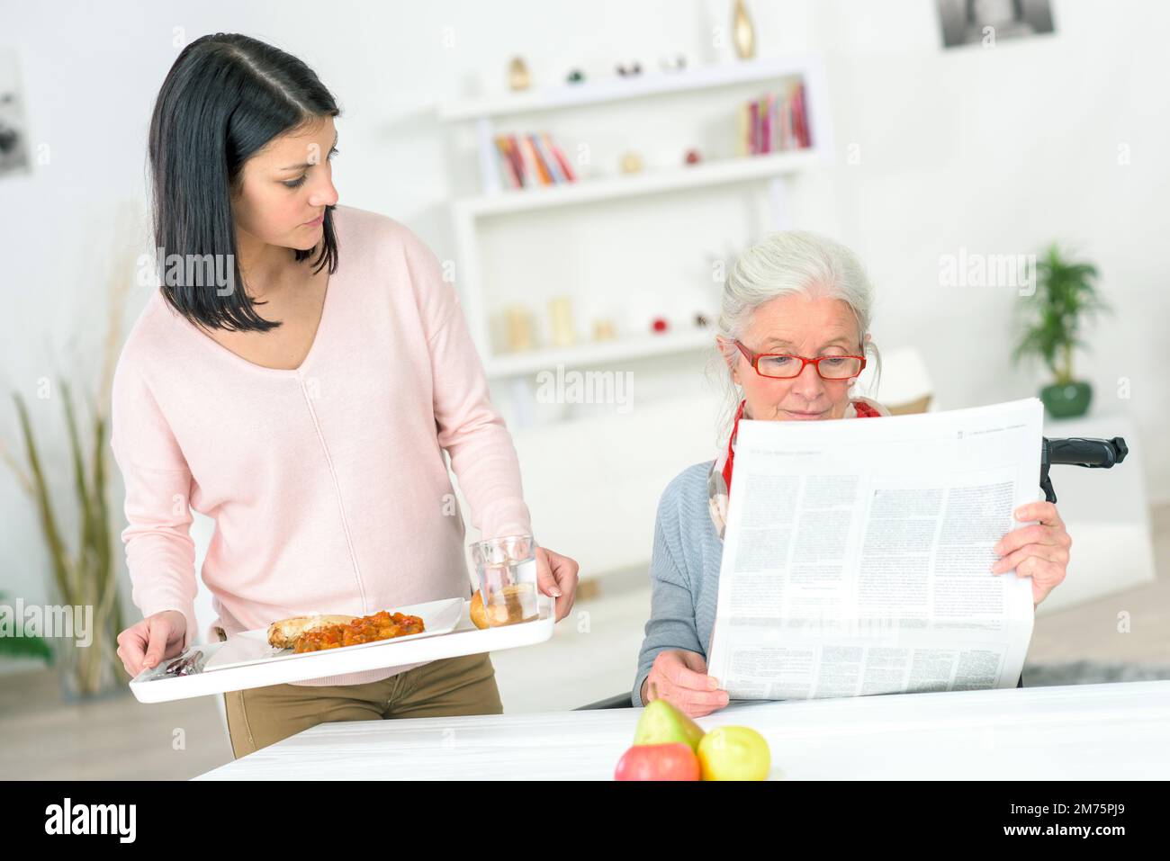 helper with an old lady Stock Photo - Alamy
