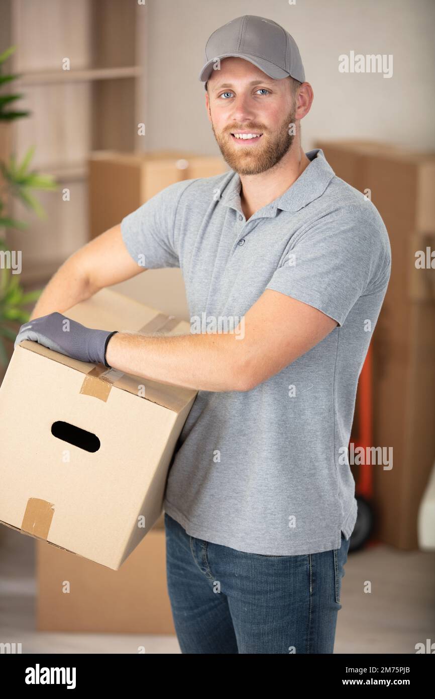 Happy handyman holding boxes hi-res stock photography and images - Alamy