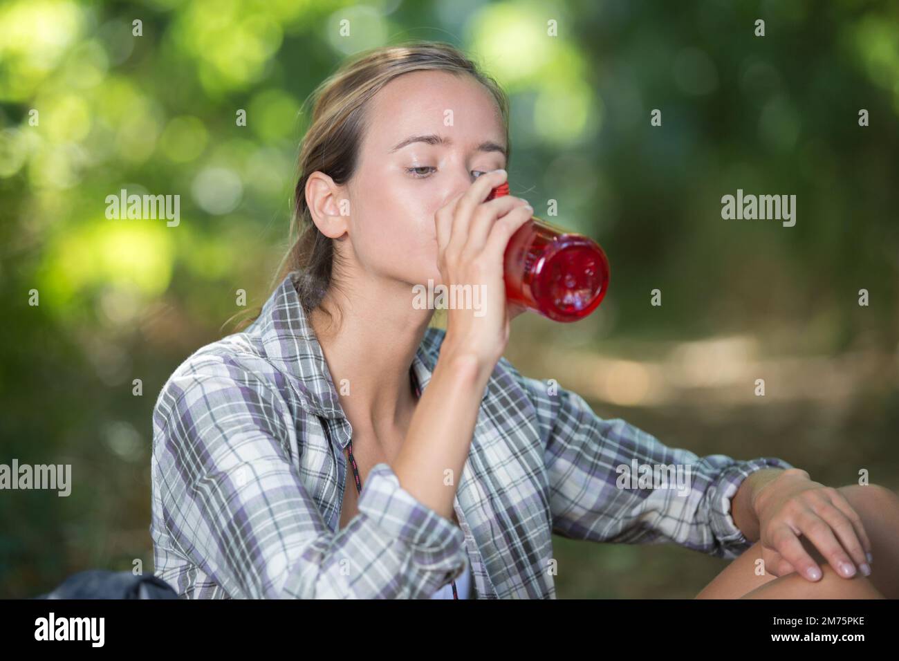 girl drinking from her water container Stock Photo - Alamy
