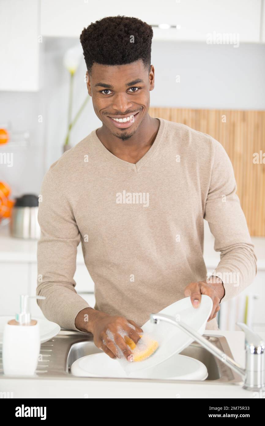 Man washing up hi-res stock photography and images - Alamy