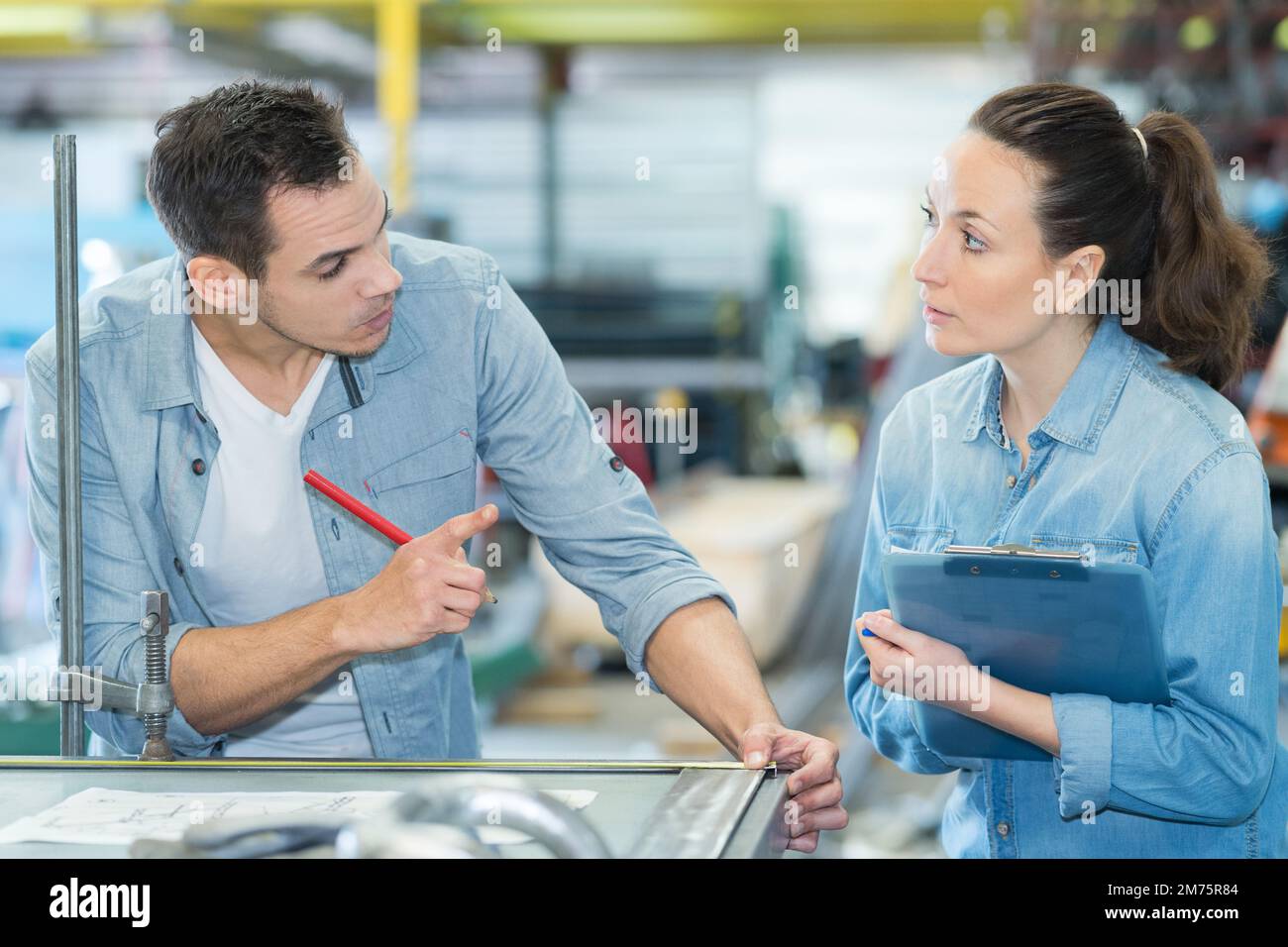 Man woman in overalls discussing hi-res stock photography and images ...