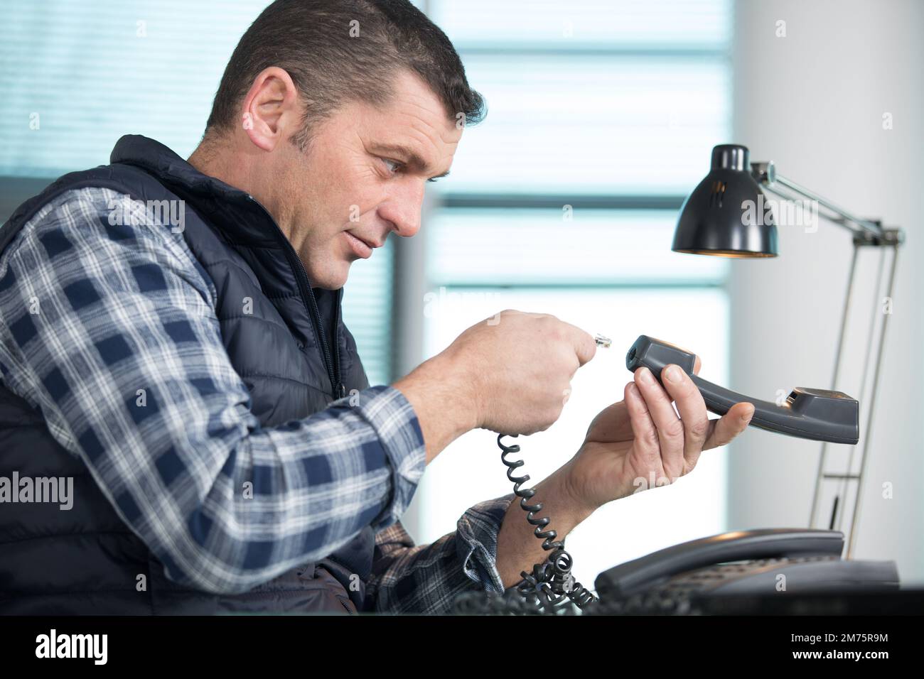 Technician repairing office phone hi-res stock photography and images ...