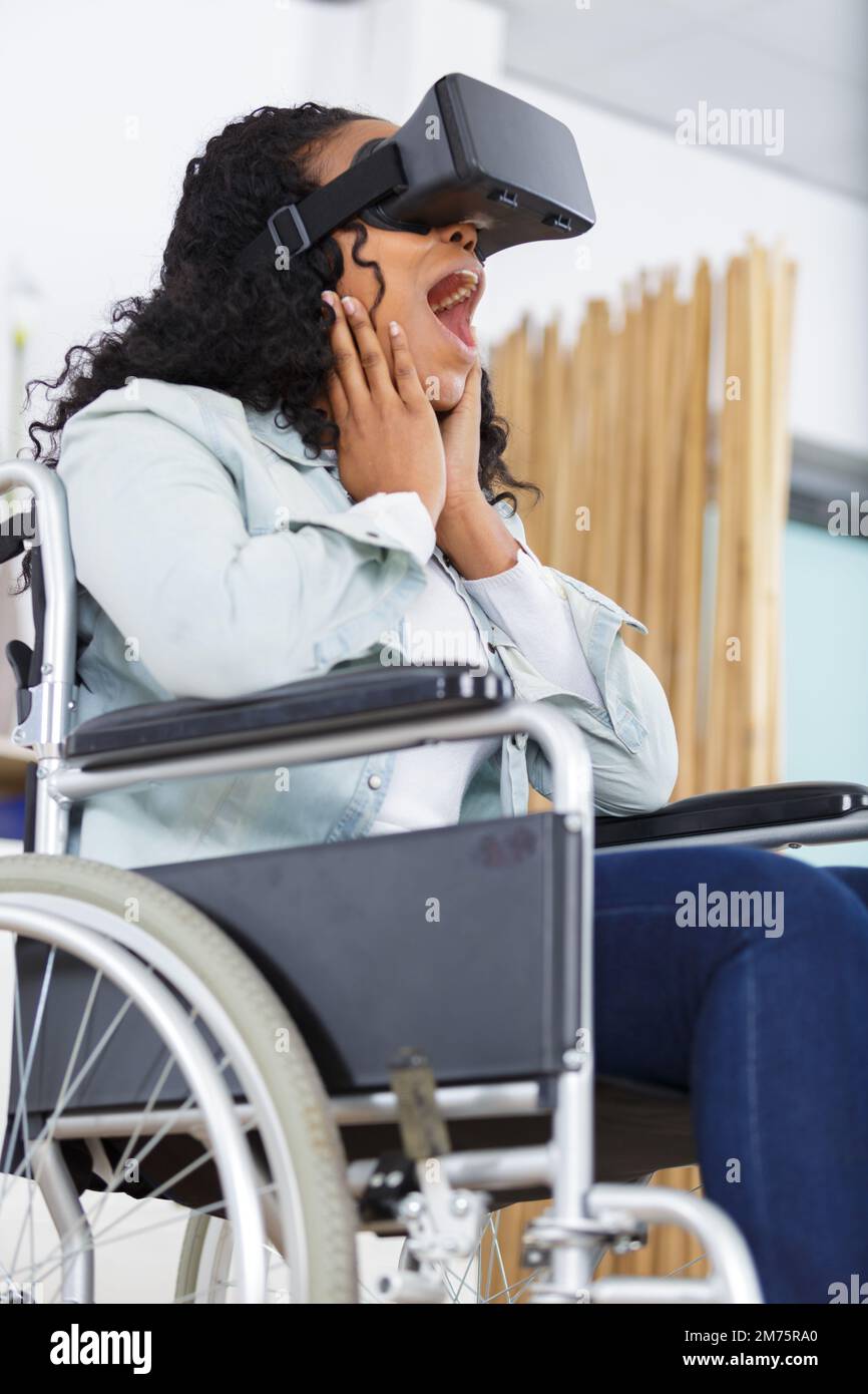 glad disabled woman wearing vr glasses Stock Photo - Alamy