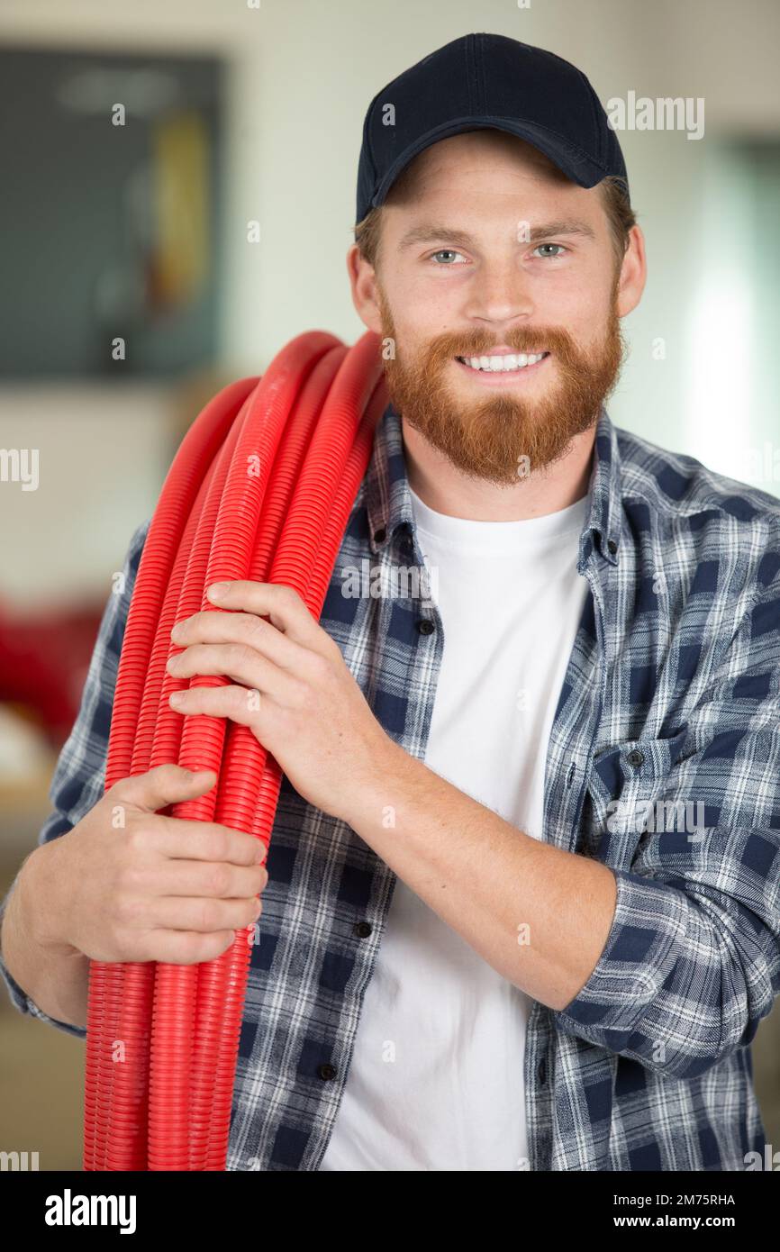 happy plumber smiling at the camera Stock Photo - Alamy