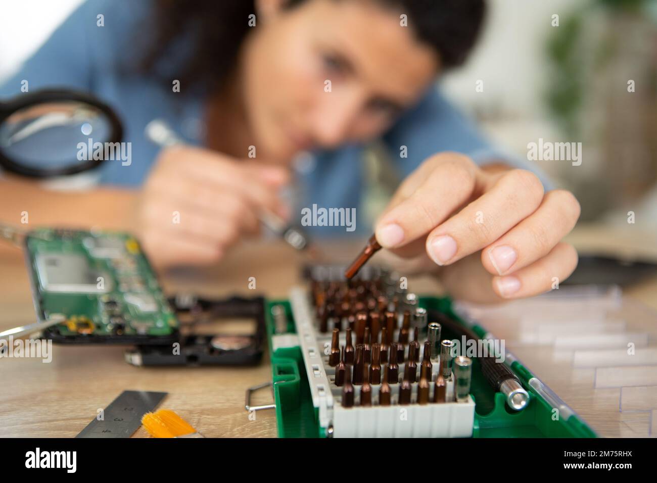 female engineer repair circuit board with small screwdriver Stock Photo ...