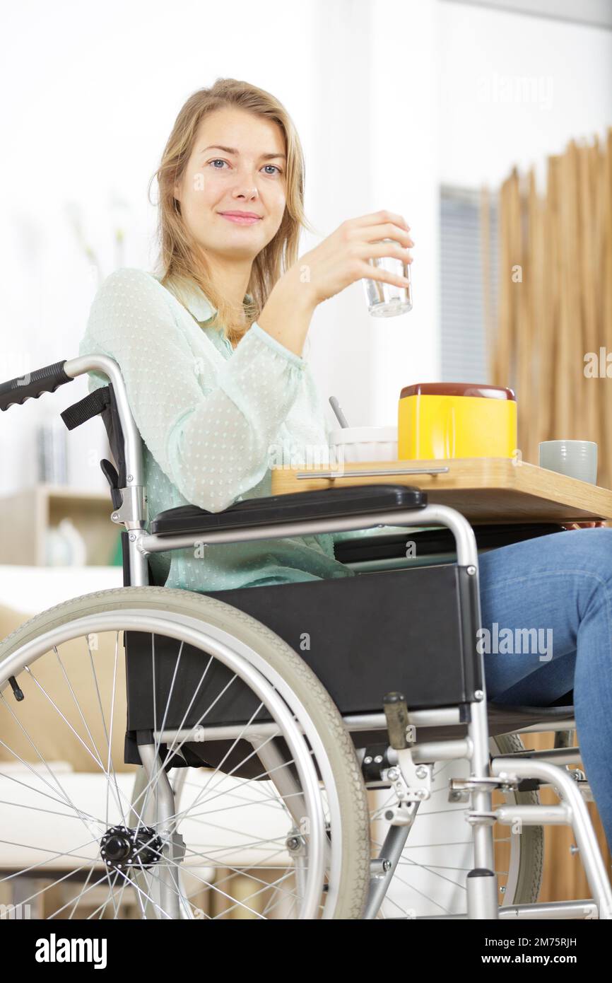 disabled woman in a wheelchair drinking water Stock Photo - Alamy