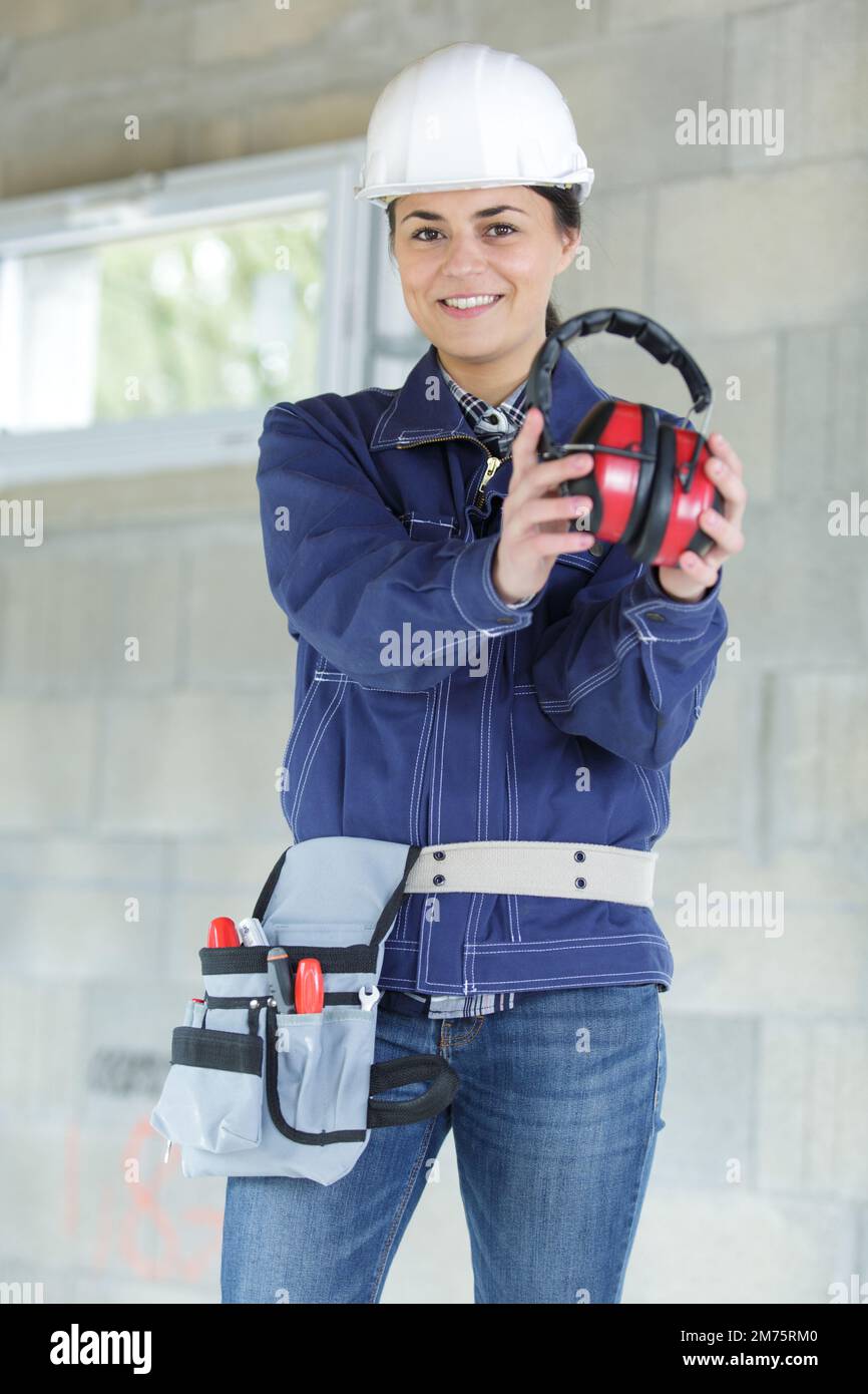 handy woman with headphones at construction site Stock Photo - Alamy