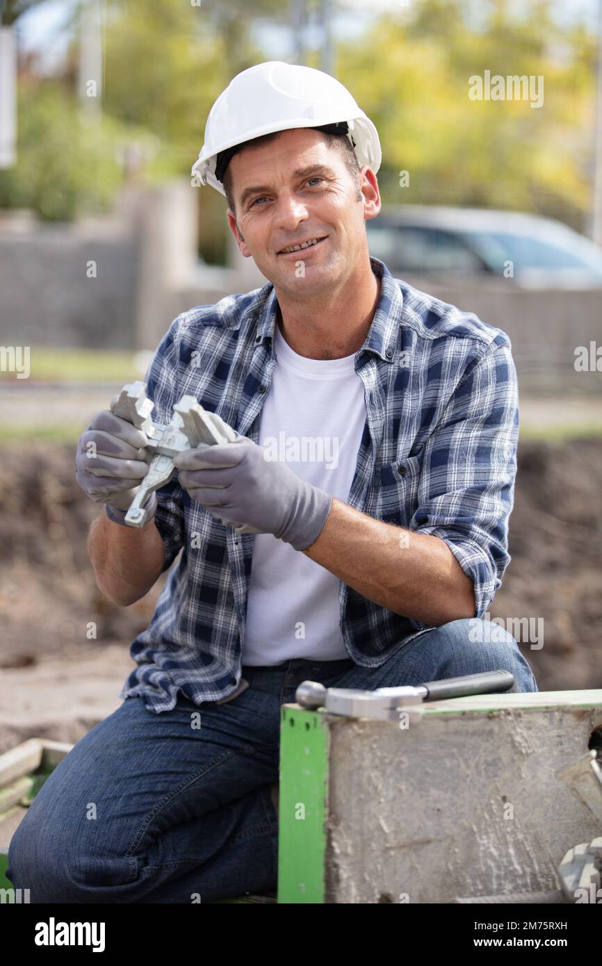builder in front of concrete works on construction site Stock Photo - Alamy