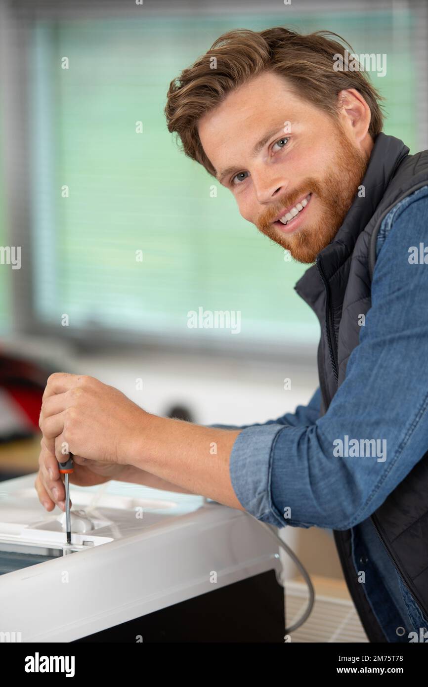 men during precision work on production line Stock Photo - Alamy