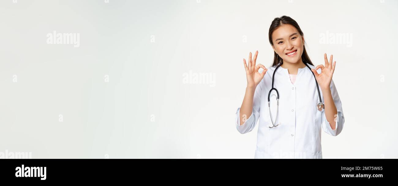 Female smiling doctor, asian healthcare worker in medical clinic ...