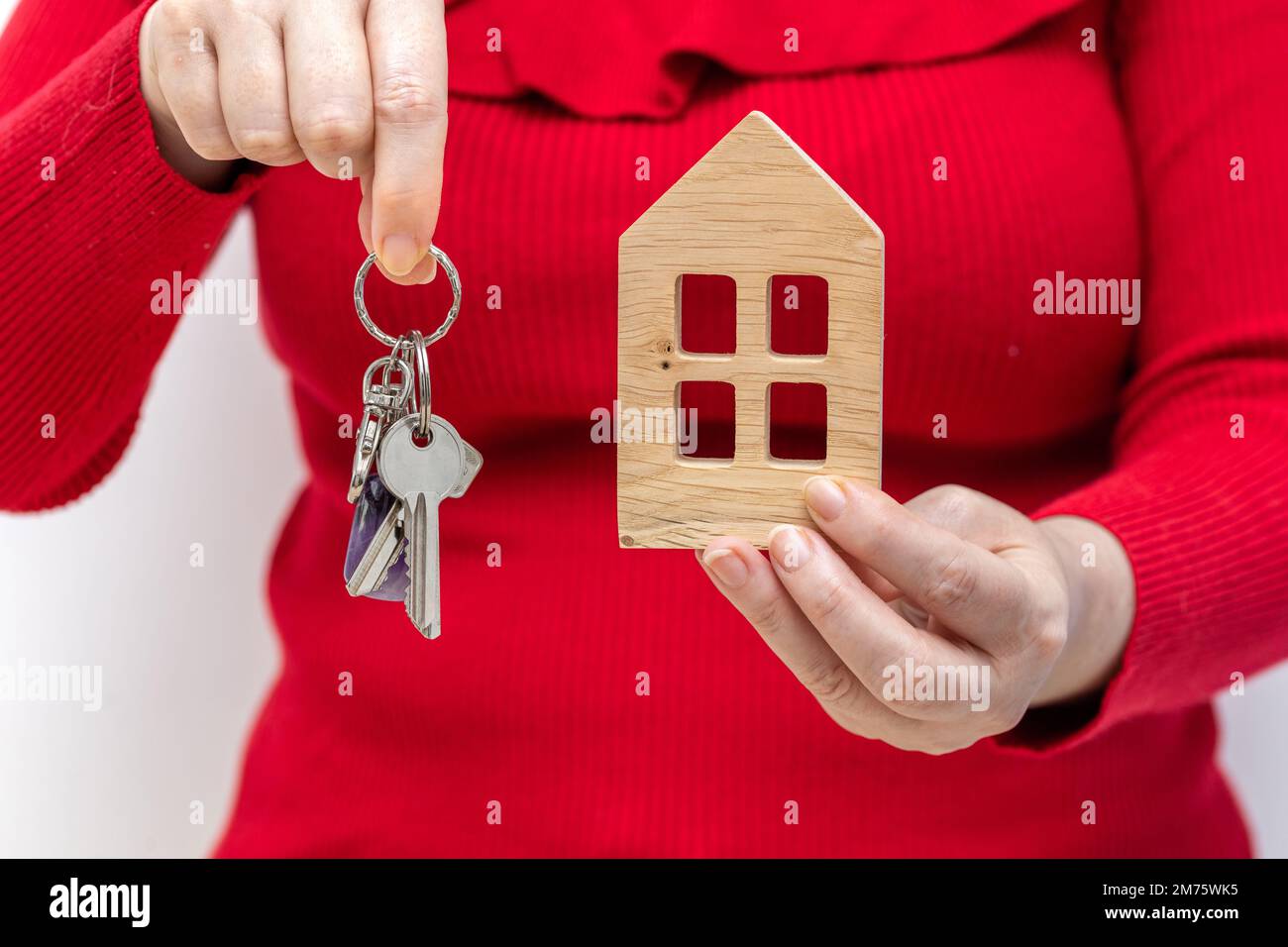 Housing concept, A woman holds the keys of her dream house and a wooden ...