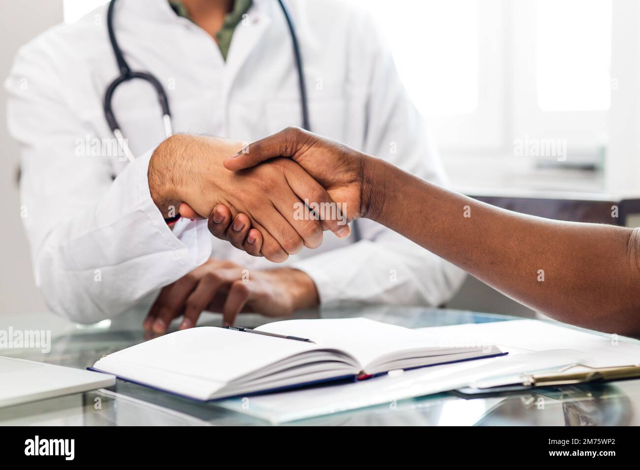 Friendly doctor hands holding patient hand support and hope concept ...