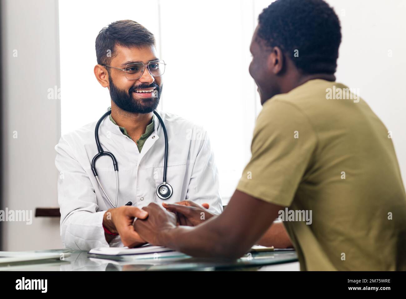 Portrait of indian man doctor talking to patient on consultation Stock ...