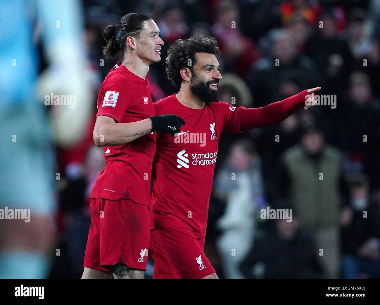 Liverpool's Mohamed Salah (right) celebrates scoring their side's ...