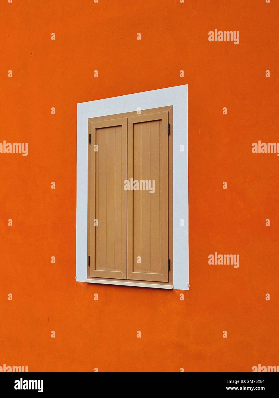 A closed window of an orange house with a copy space Stock Photo - Alamy