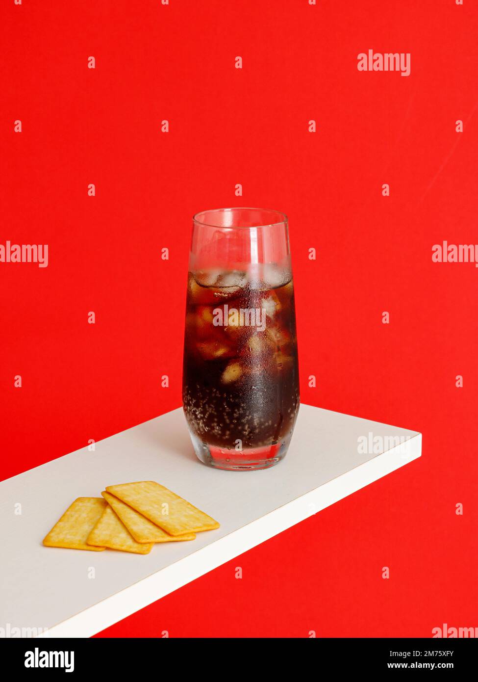 A Cold carbonated drink with ice cubes and Cracker Biscuit isolated on ...