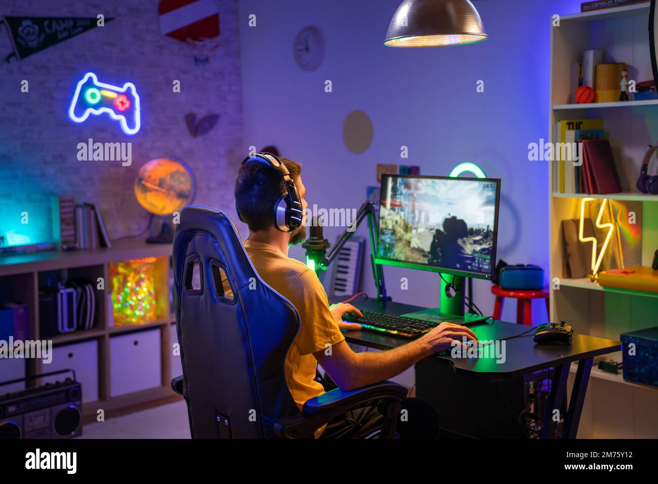 Professional Gamer Playing Online Video Game on Computer with Colorful ...