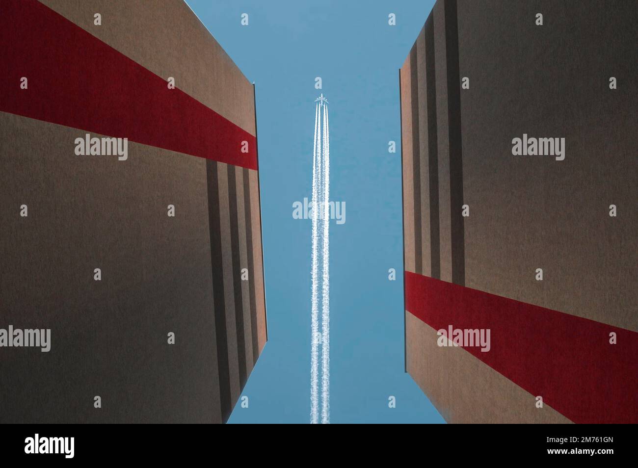A low angle shot of a plane flying through the buildings Stock Photo ...