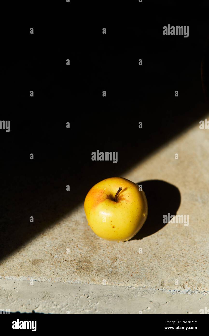 Fresh yellow apple on a gray background Stock Photo - Alamy
