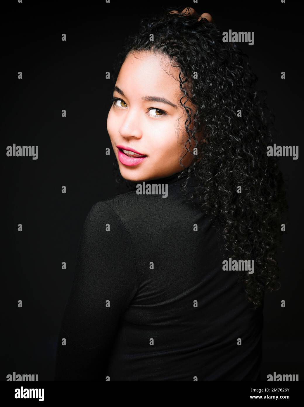 Beautiful Young Multiracial Woman Seated Facing Camera Stock Photo - Alamy