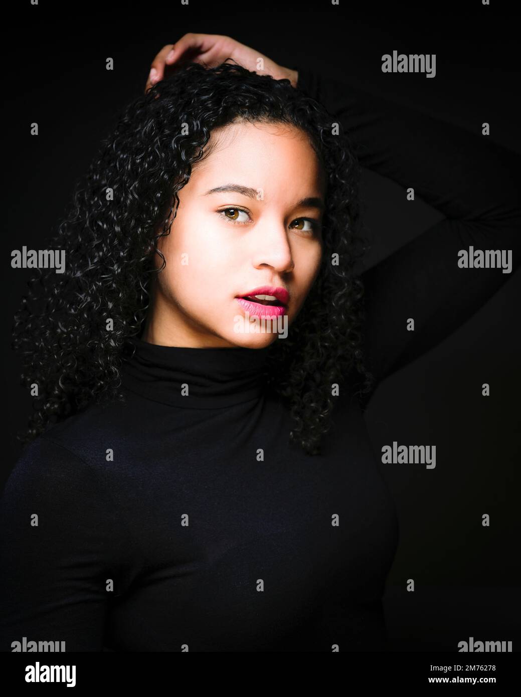 Beautiful Young Multiracial Woman Seated Facing Camera Stock Photo - Alamy