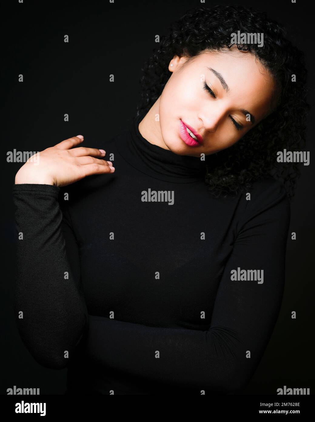 Beautiful Young Multiracial Woman Seated Facing Camera Stock Photo - Alamy