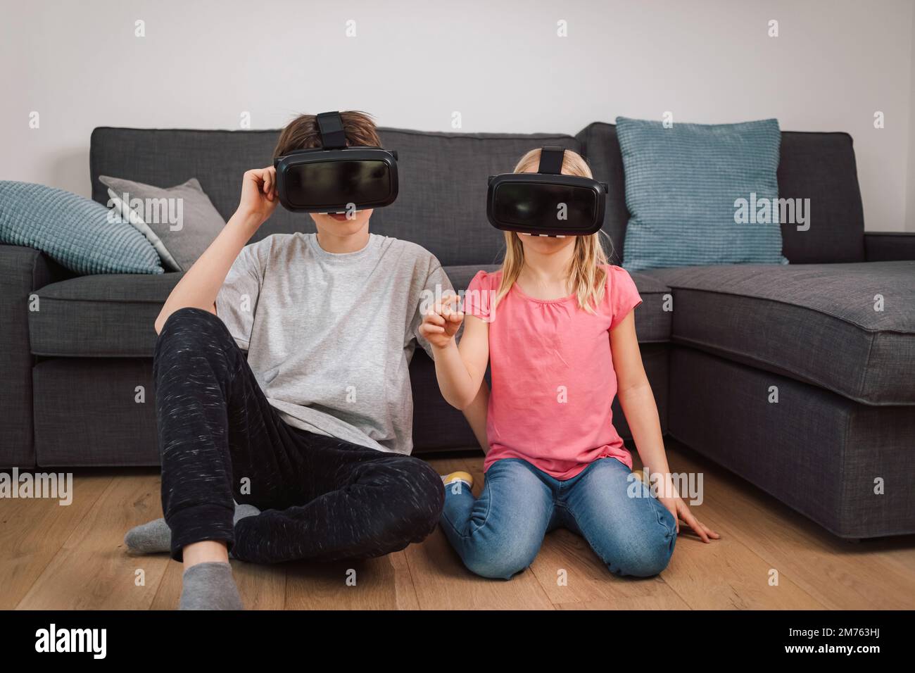Two Caucasian children, brother, and sister having fun playing at home ...