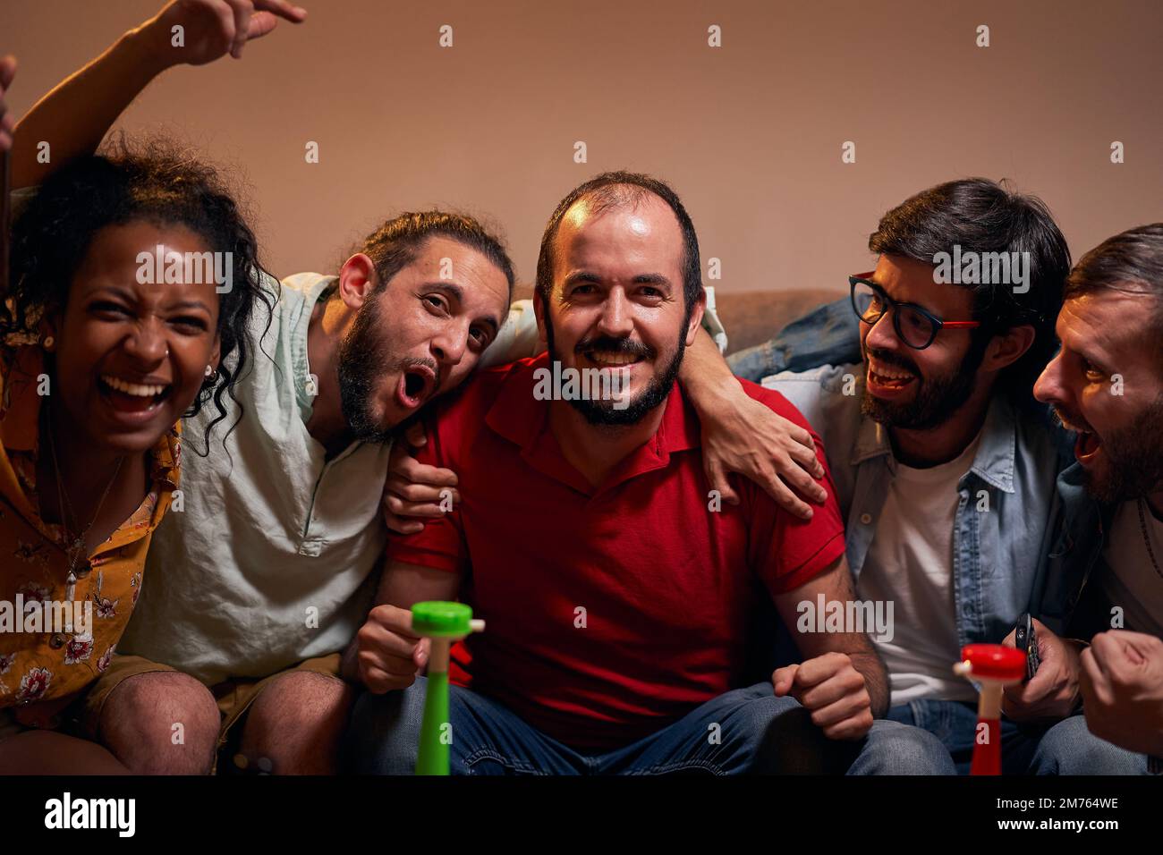 Joyful football fans cheering for favorite team while watching match on ...