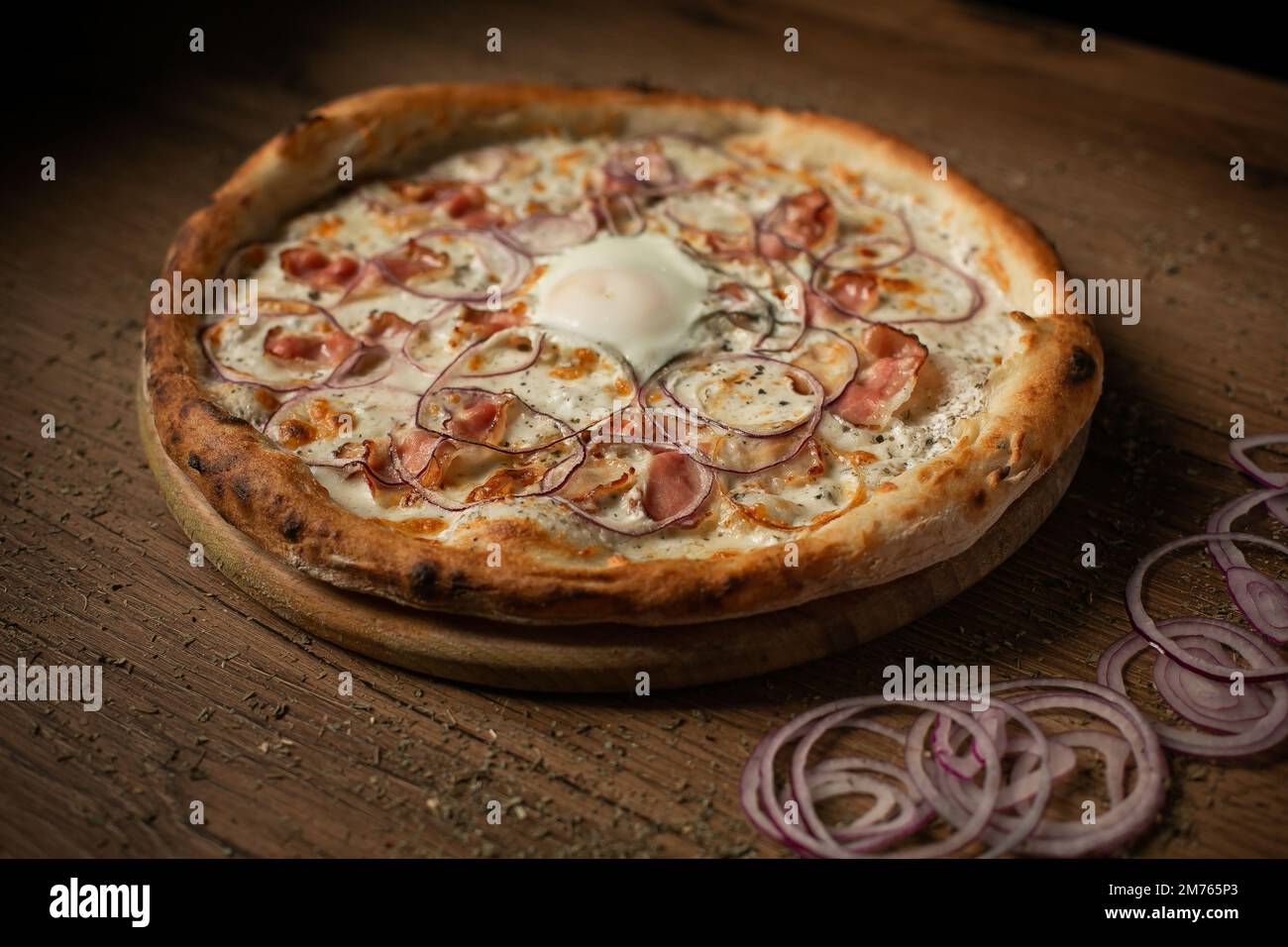 delicious pizza with ham, onions and fried eggs in the middle Stock ...
