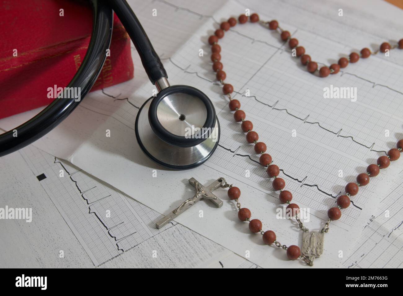 A stethoscope next to a crucifix with the image of Christ on an ...