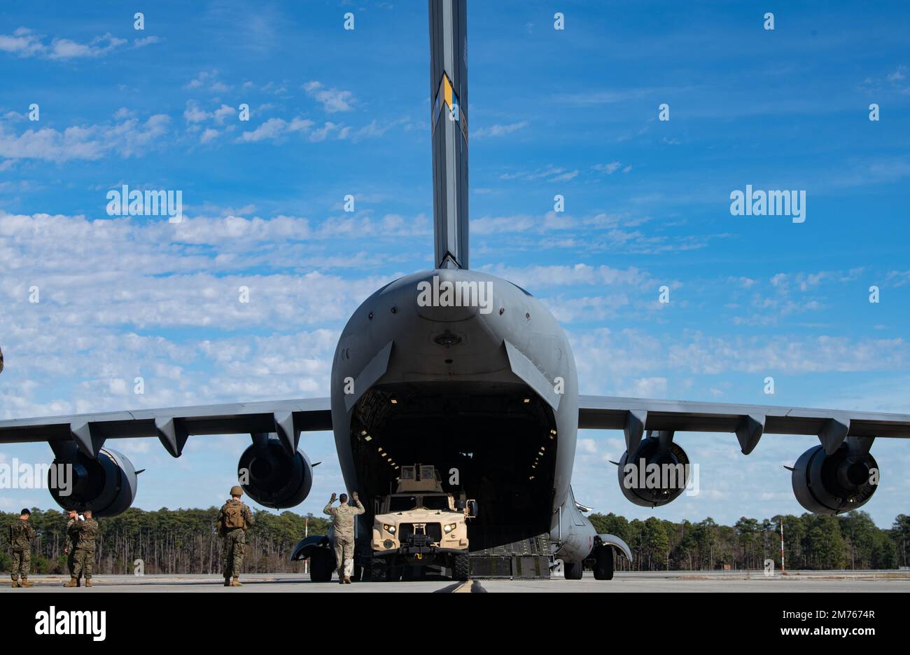 U.S. Service Members load a joint light tactical vehicle onto a C-17 ...