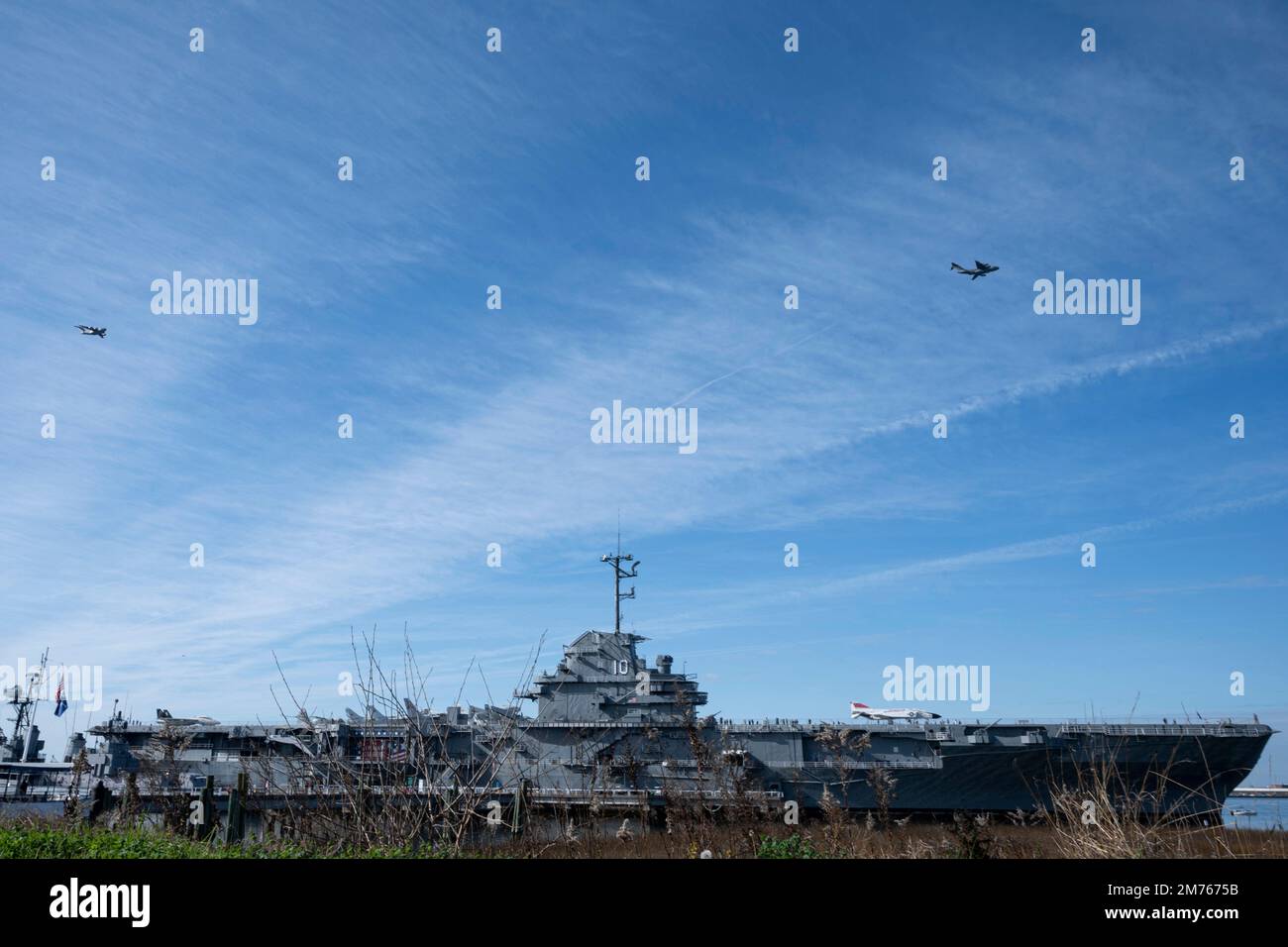 U.S. Air Force C-17 Globemaster III's fly above the USS Yorktown (CV 10 ...