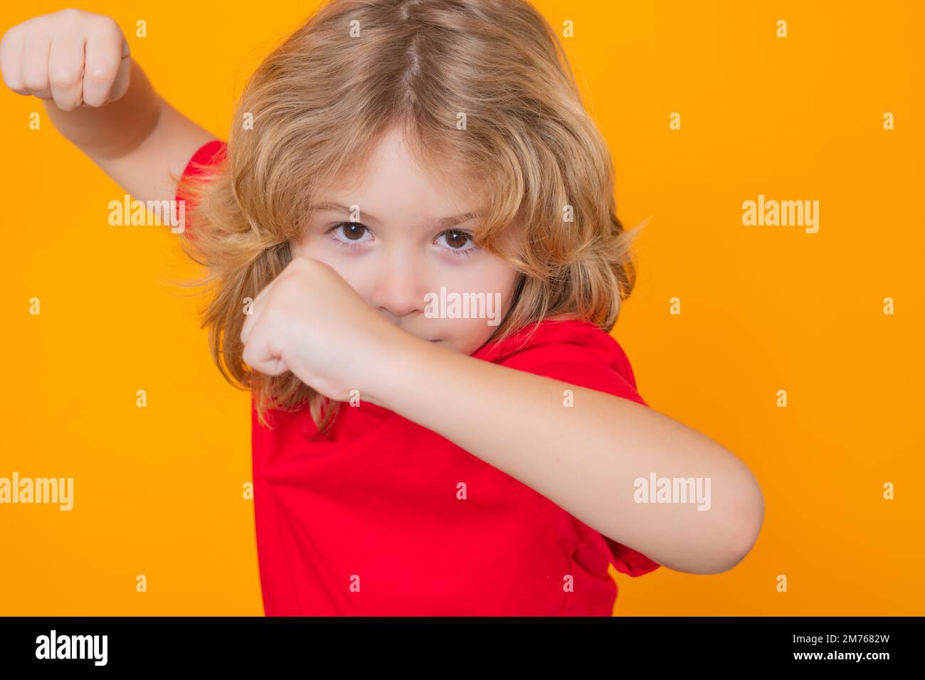 Child with fist gesture fight. Andry child boy in red t-shirt making ...