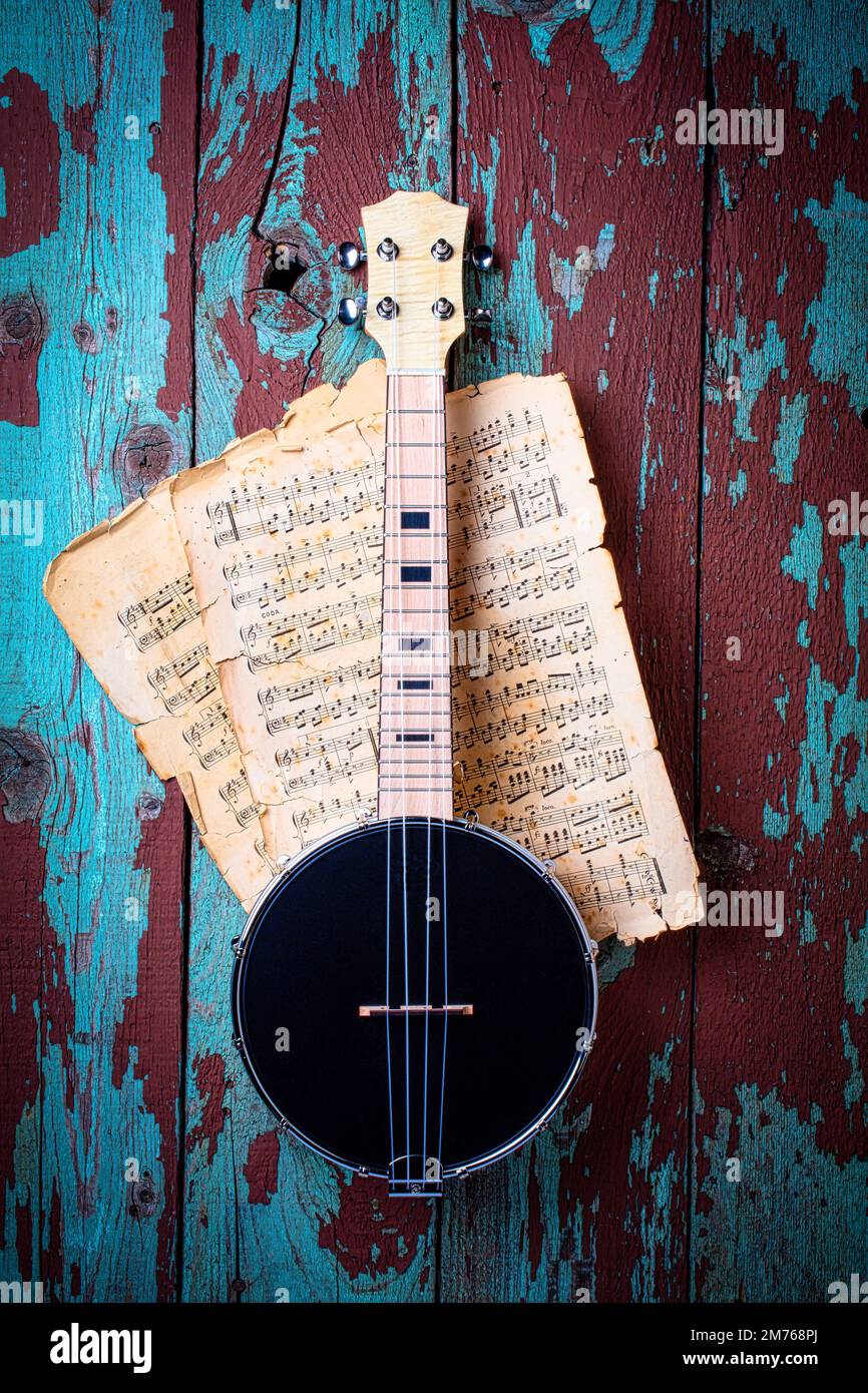 Black Banjo On Rustic Wall Stock Photo - Alamy