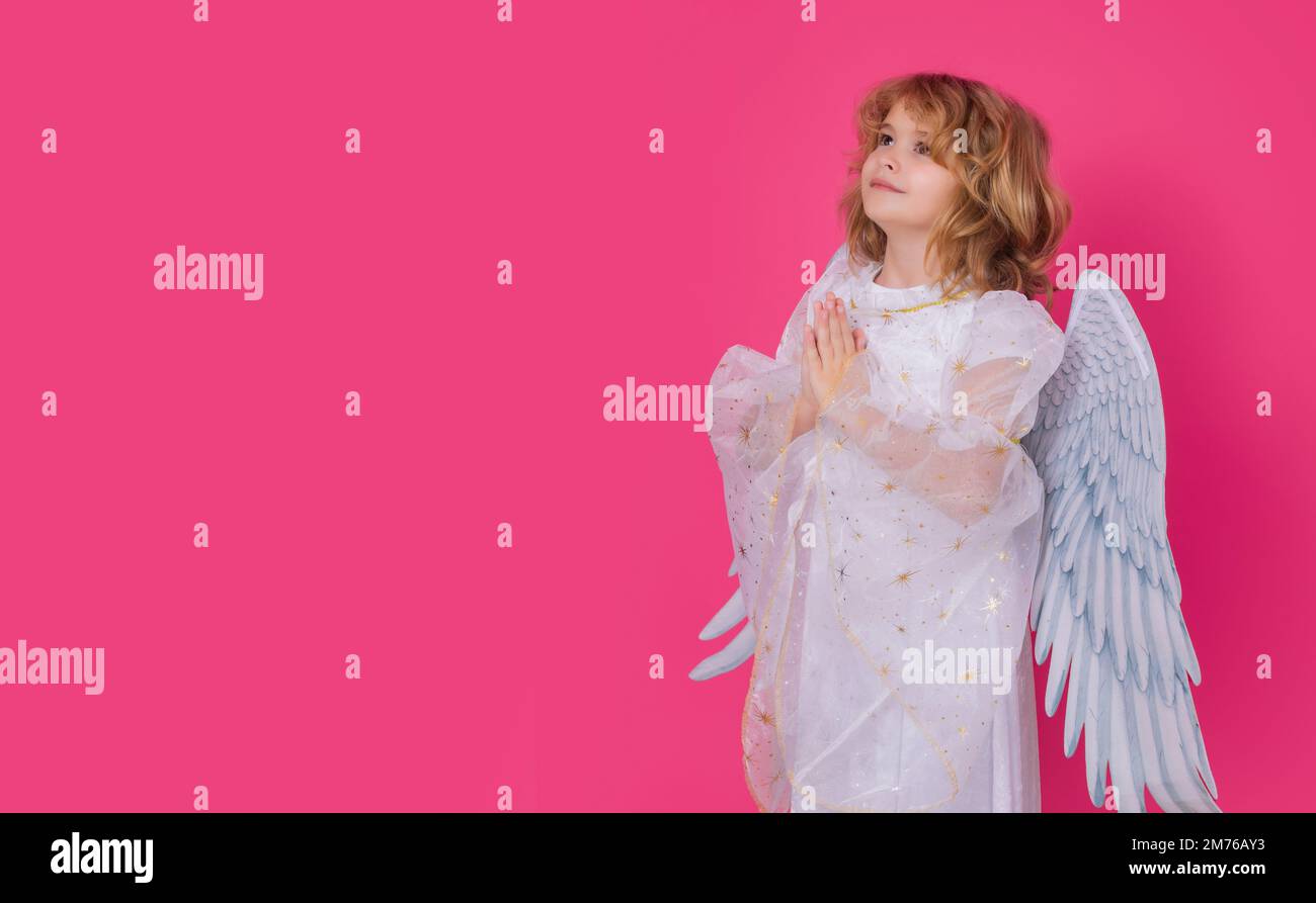 Angel prayer. Angel child. Isolated studio shot. Cute kid with angel ...