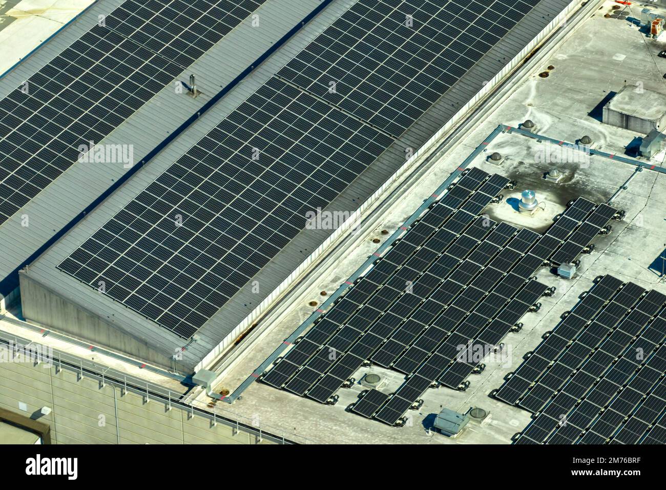 Aerial view of blue photovoltaic solar panels mounted on industrial ...