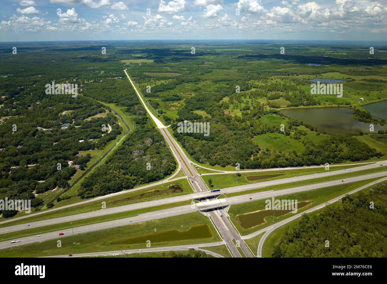 Aerial view of freeway overpass junction with fast moving traffic cars ...