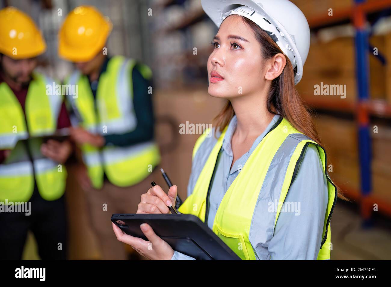 Worker in warehouse holding check list tablet pc stand portrait photo ...