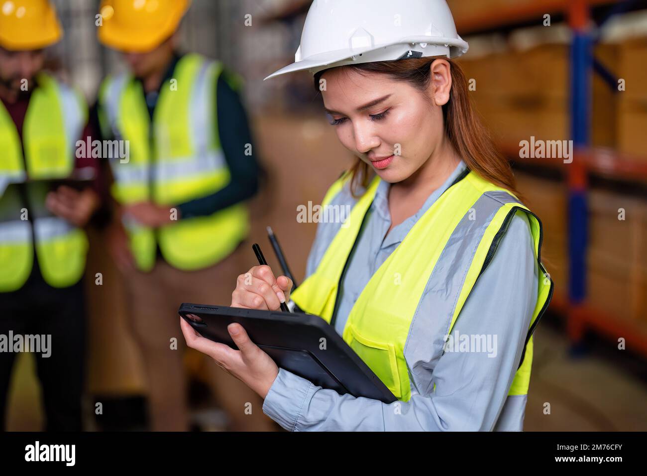 Worker in warehouse holding check list tablet pc stand portrait photo ...