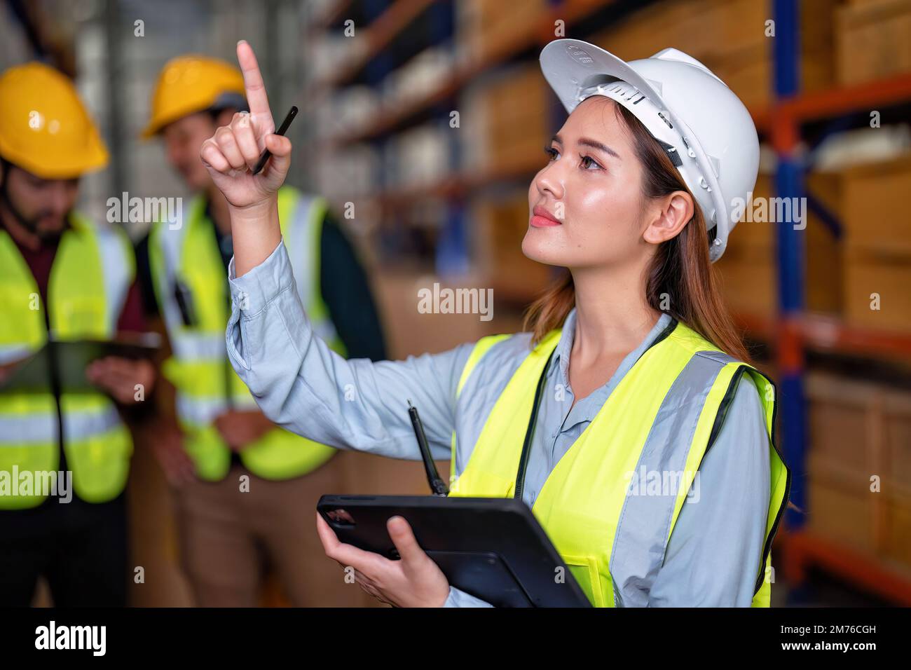 Worker in warehouse holding check list tablet pc stand portrait photo ...