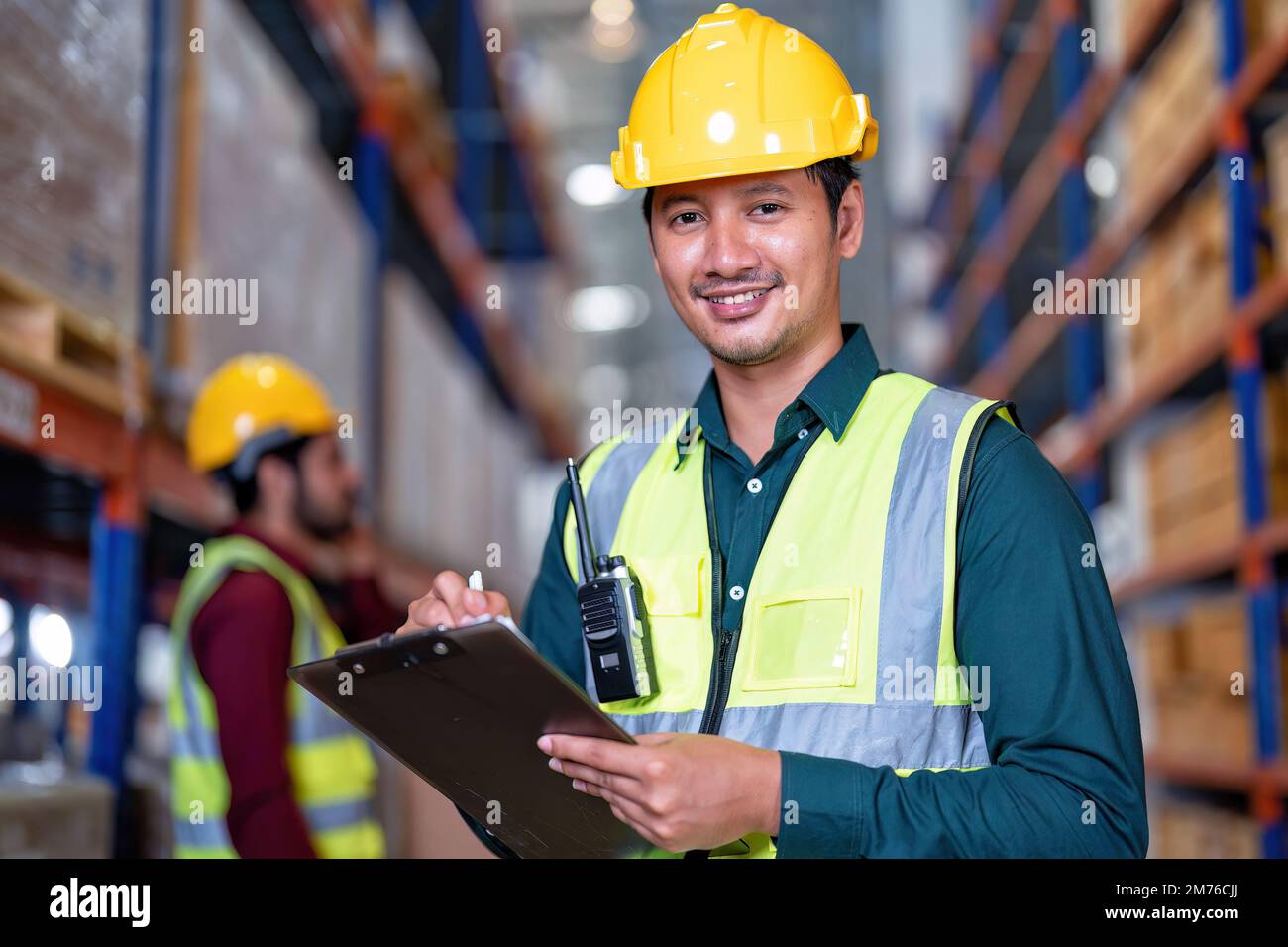 Worker in warehouse holding check list tablet pc stand portrait photo ...