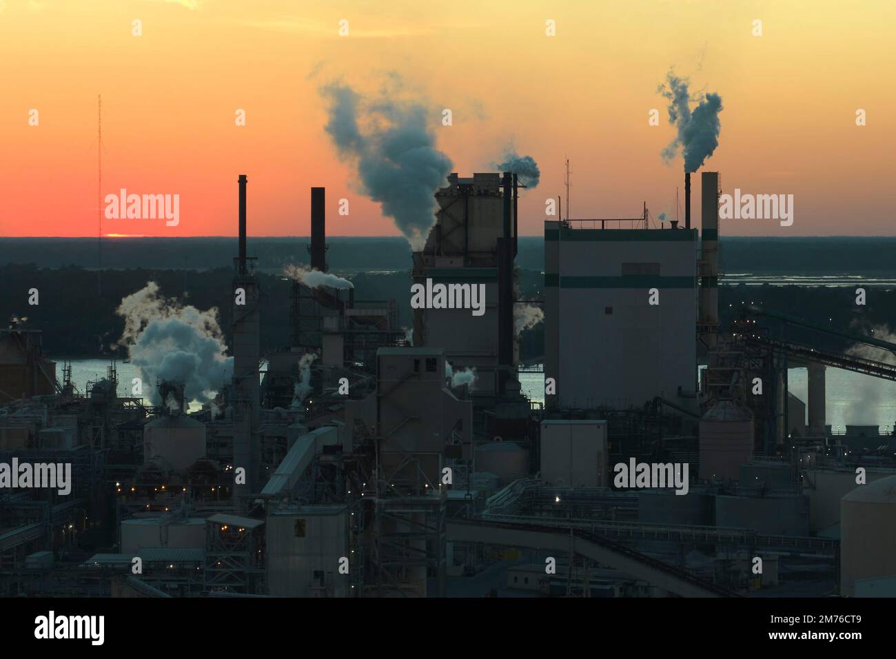 Aerial view of large factory with smokestack from production process ...