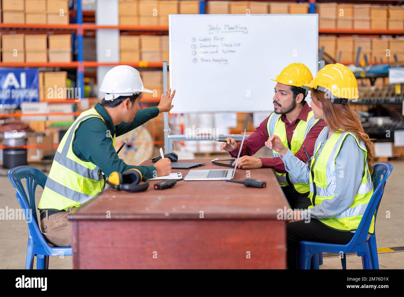 Group of worker in the warehouse factory conduct toolbox talk daily meeting focus on safety ...