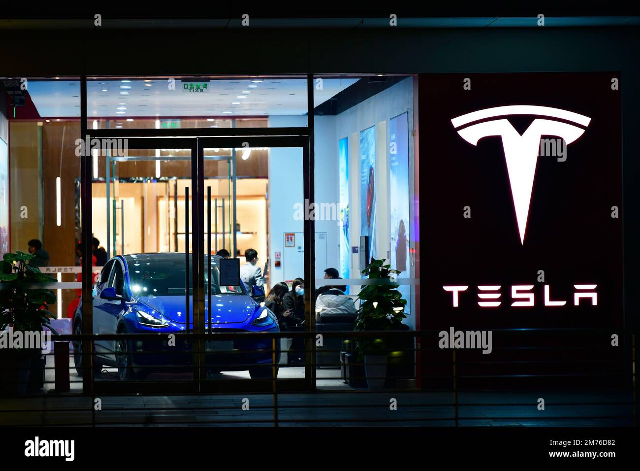 BEIJING, CHINA - JANUARY 8, 2023 - Car owners are seen at a Tesla store ...