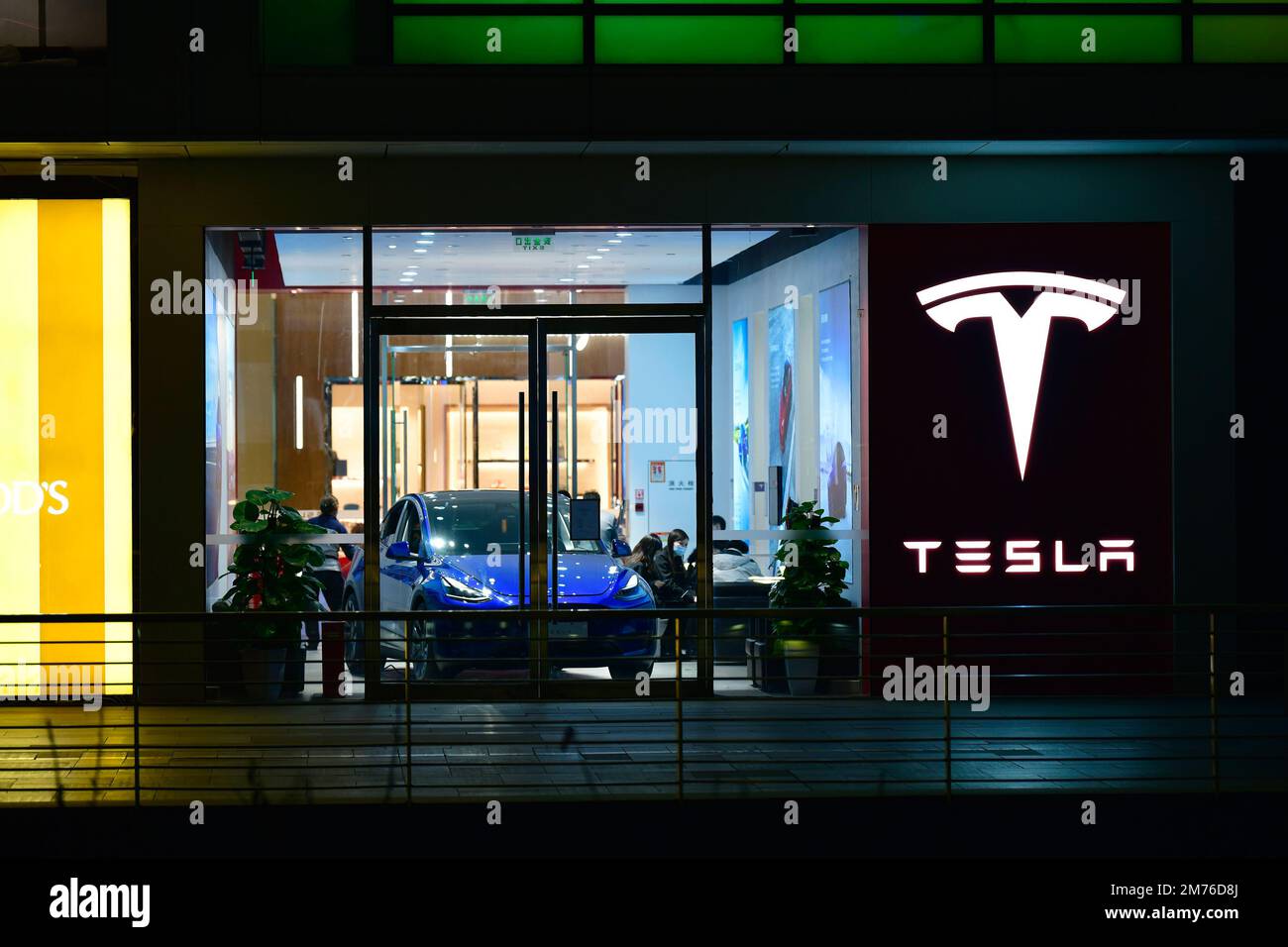 BEIJING, CHINA - JANUARY 8, 2023 - Car owners are seen at a Tesla store ...