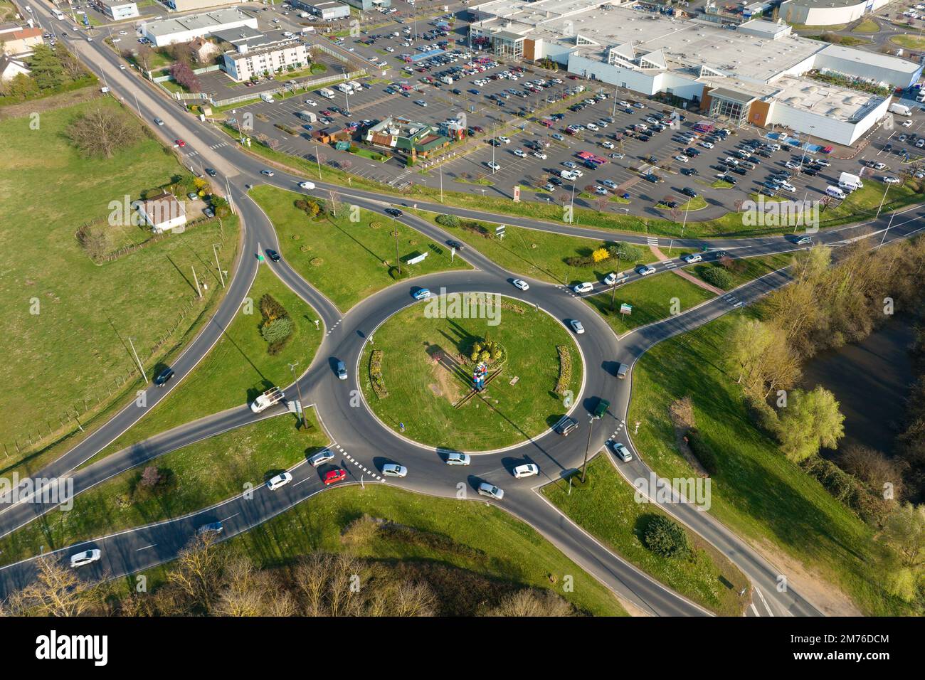 Aerial view of road roundabout intersection with moving heavy traffic. Urban circular ...