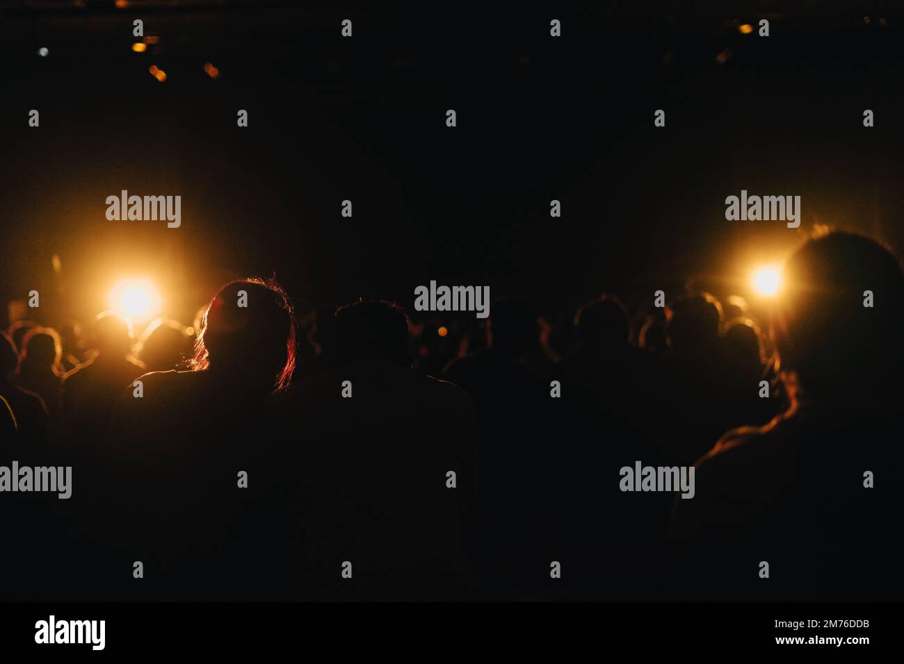 A silhouette of a crowd facing two bright lights background Stock Photo ...