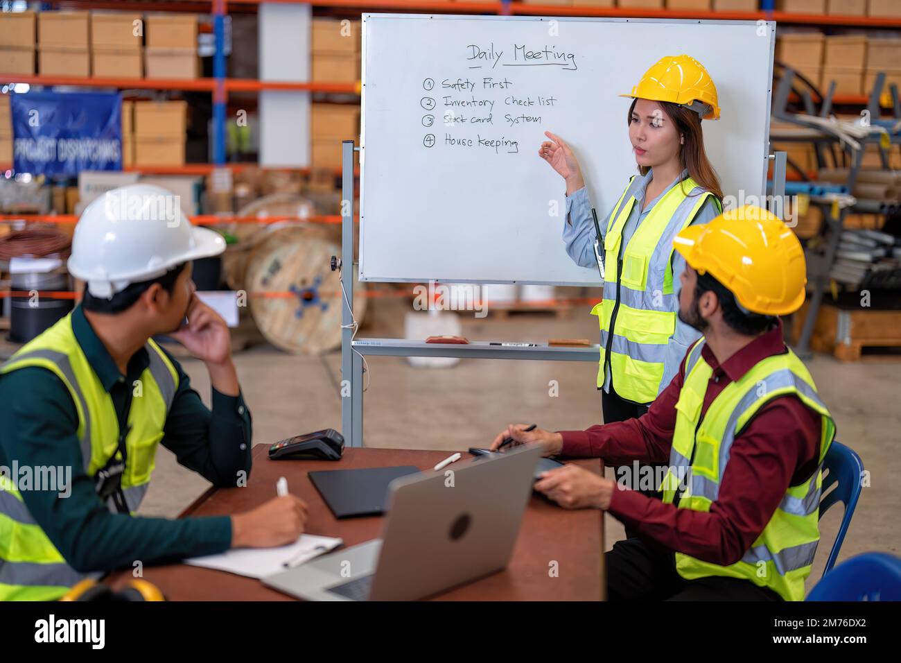 Group of worker in the warehouse factory conduct toolbox talk daily ...
