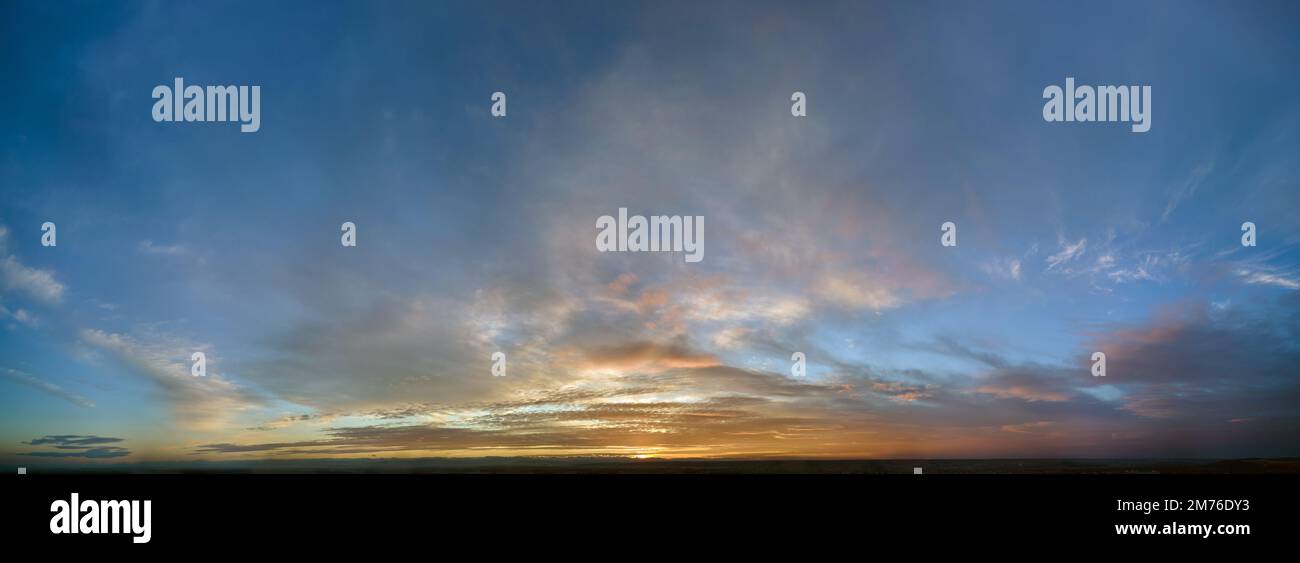 Bright colorful sunset sky with vivid smooth clouds illuminated with ...