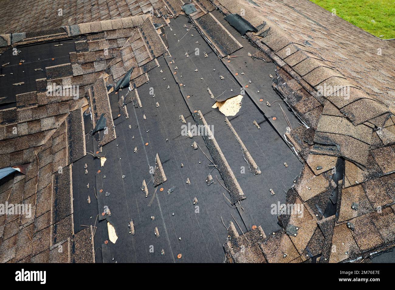 Damaged house roof with missing shingles after hurricane Ian in Florida ...